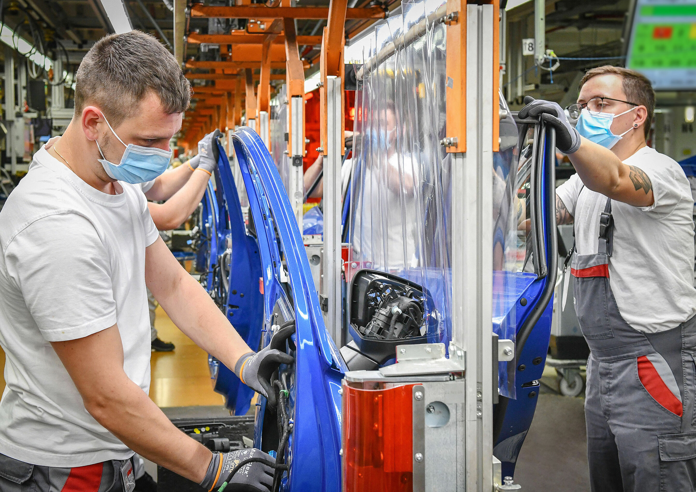 People Working In A Car Factory